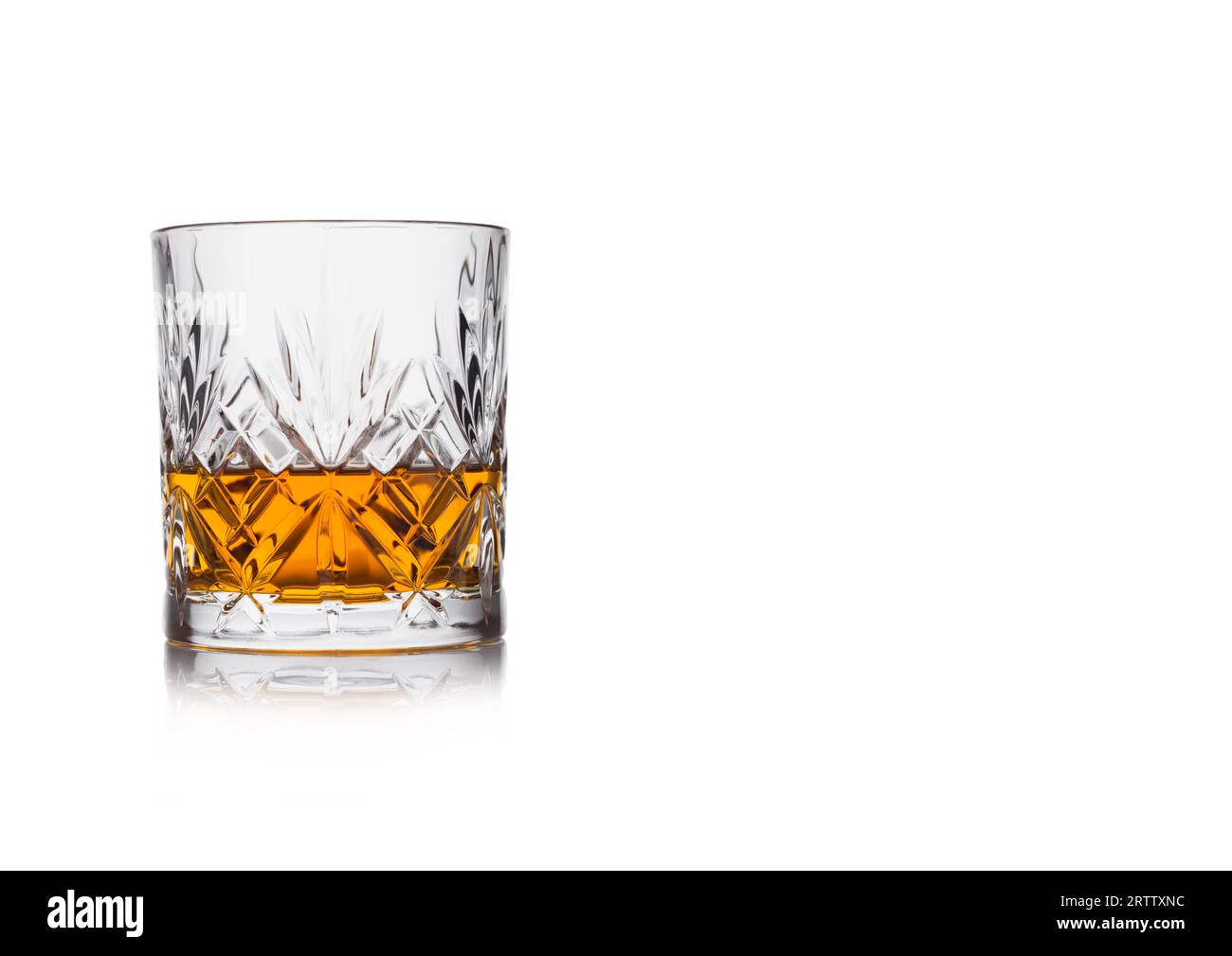Scotch whiskey in crystal elegant glass on white background with ...