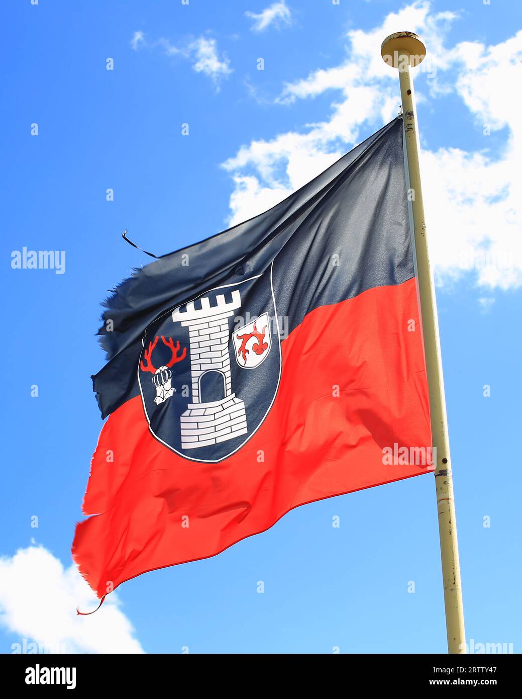 Ragged flag of the city of Blankenburg in Germany, blowing in the wind ...