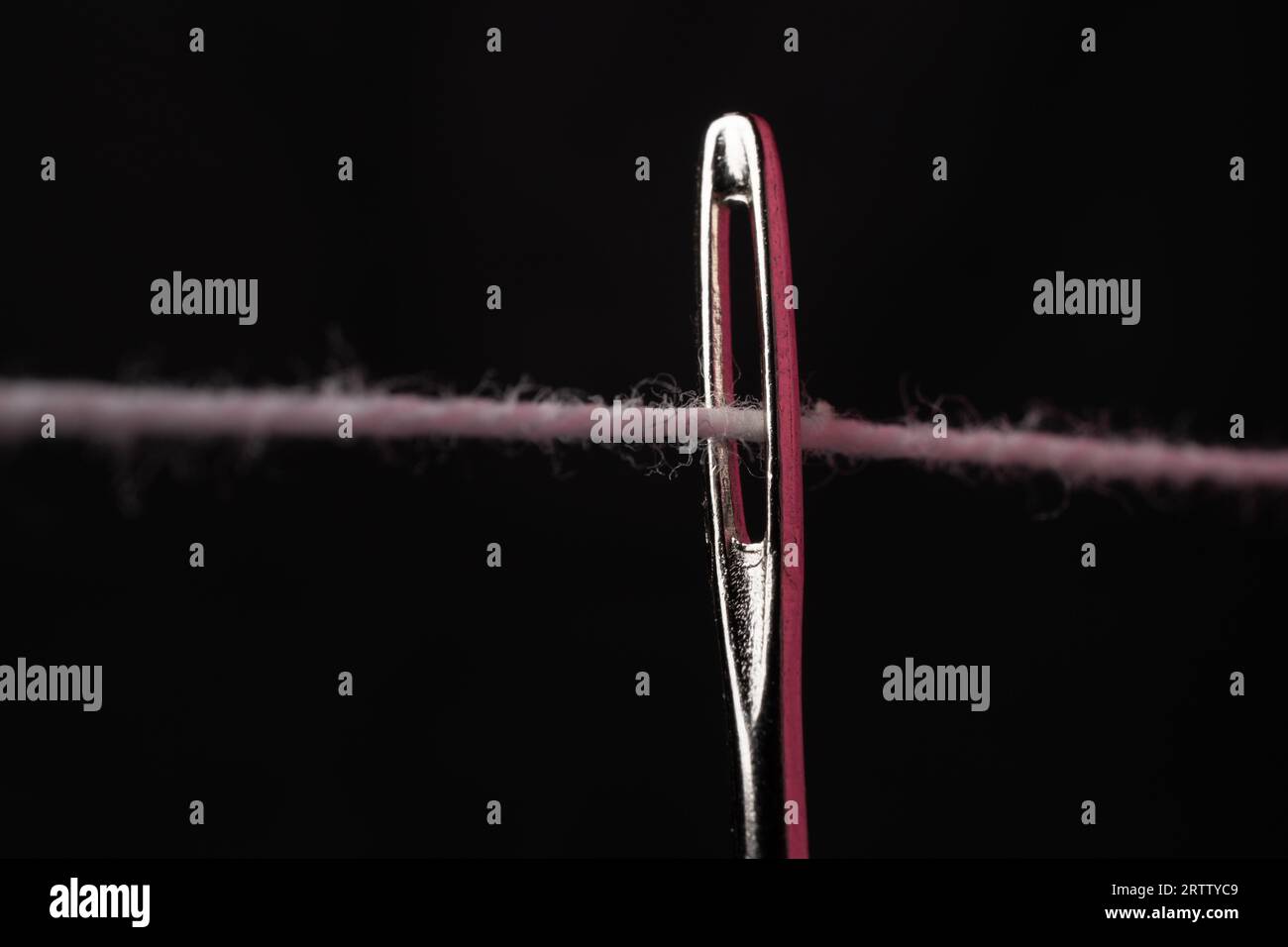 closeup photo of sewing thread in needle hole Stock Photo - Alamy