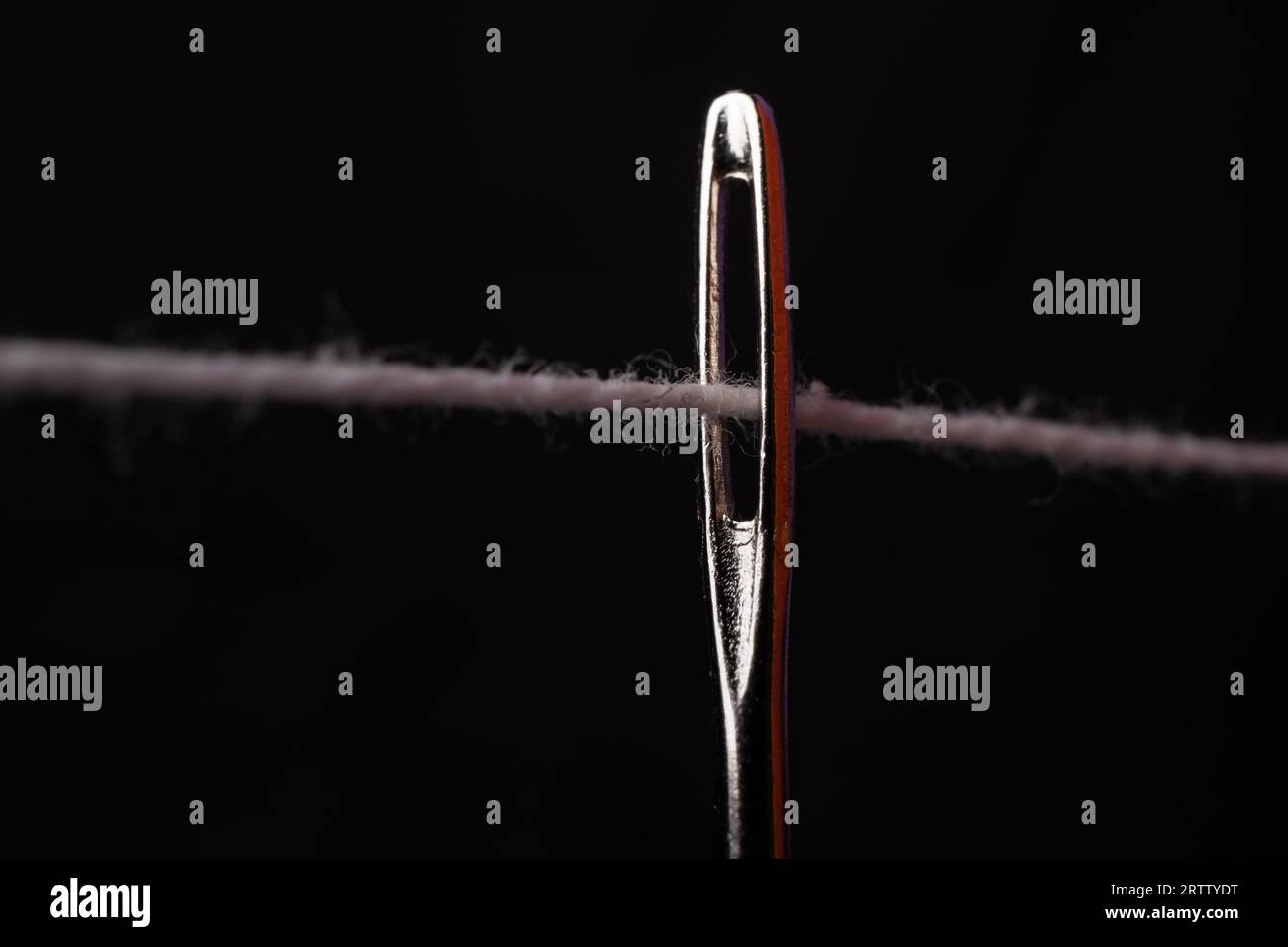 closeup photo of sewing thread in needle hole Stock Photo - Alamy
