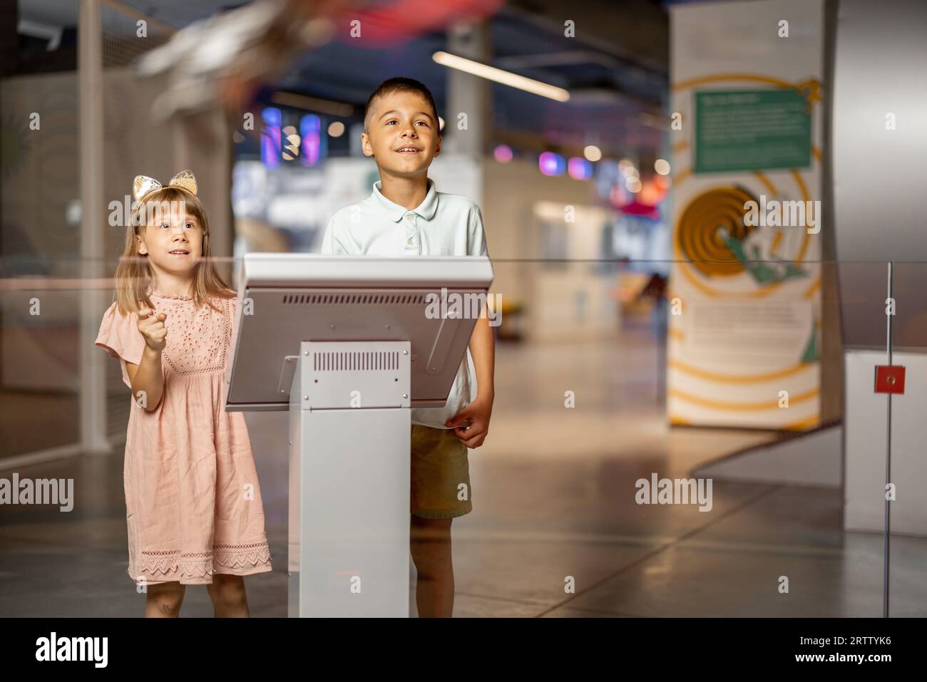 Boy and girl interact with a robot in science museum Stock Photo - Alamy