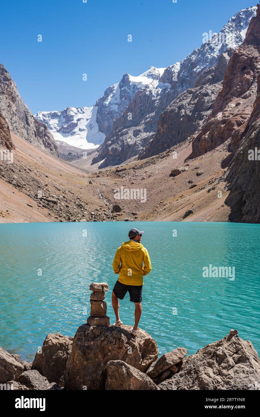 Man hiker exploring mountains lake in Tajikistan Stock Photo - Alamy