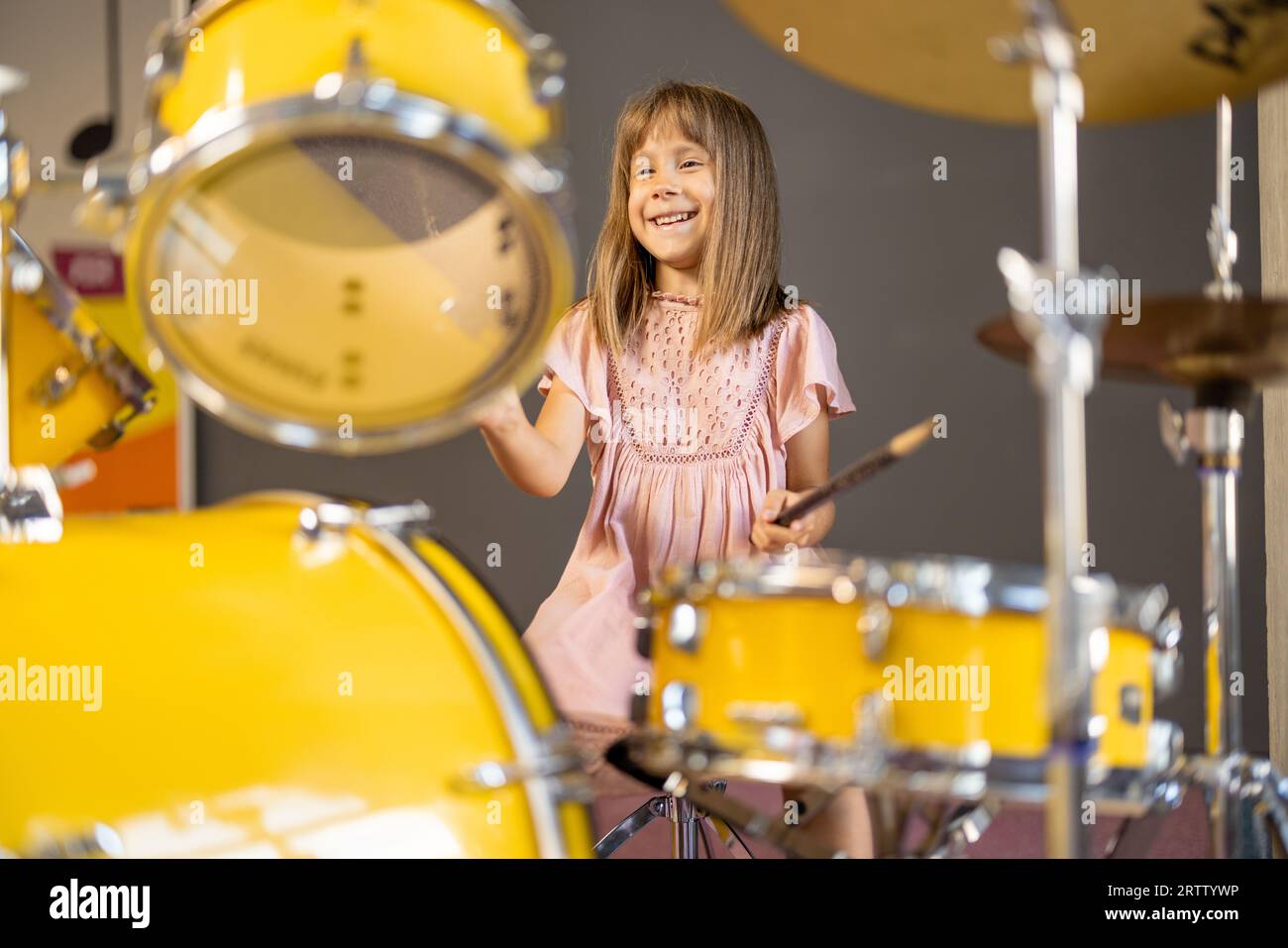 Girl playing on a real drums Stock Photo - Alamy