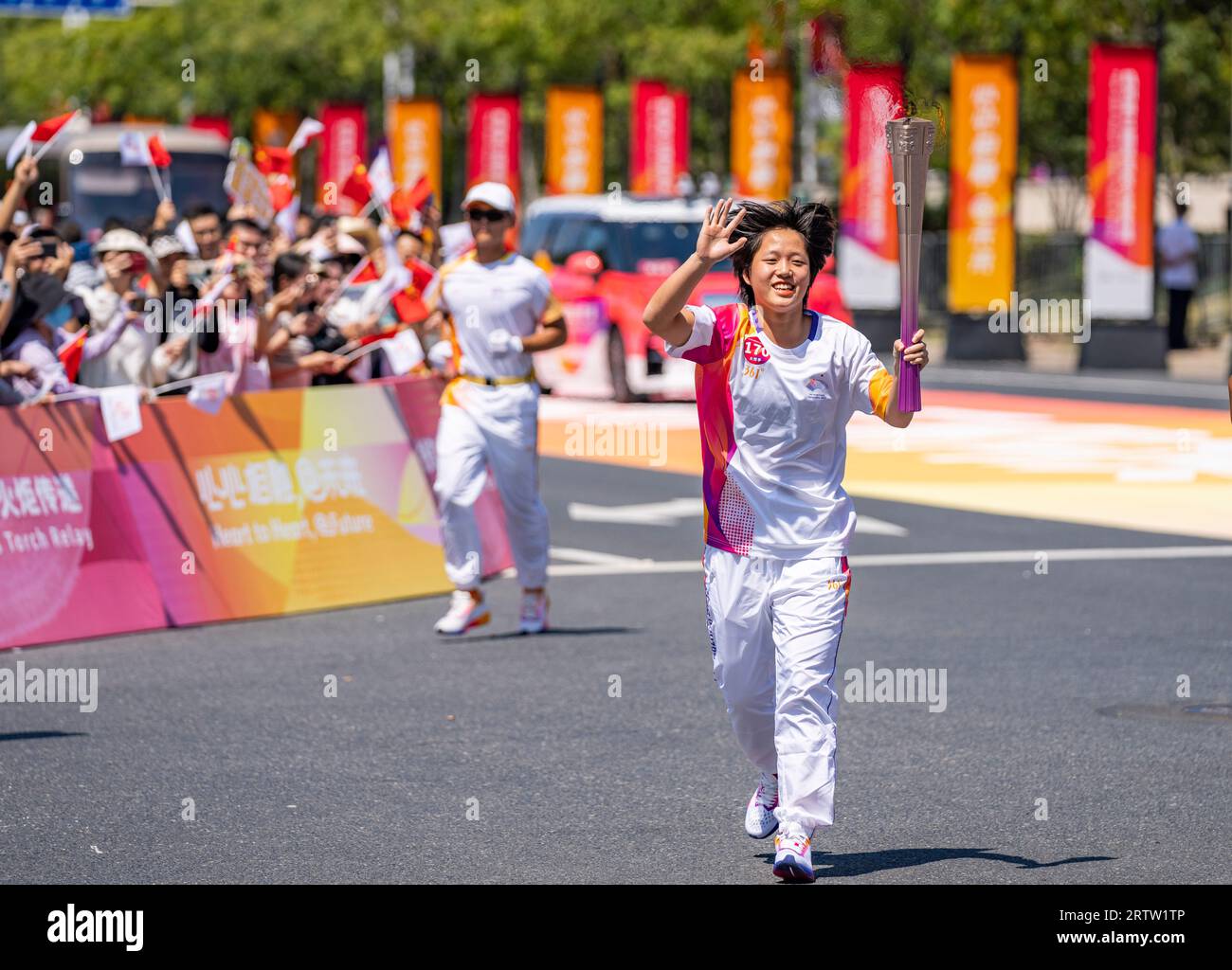Wenzhou, China's Zhejiang Province. 15th Sep, 2023. Torch bearer Fang Yuting runs with the torch ...