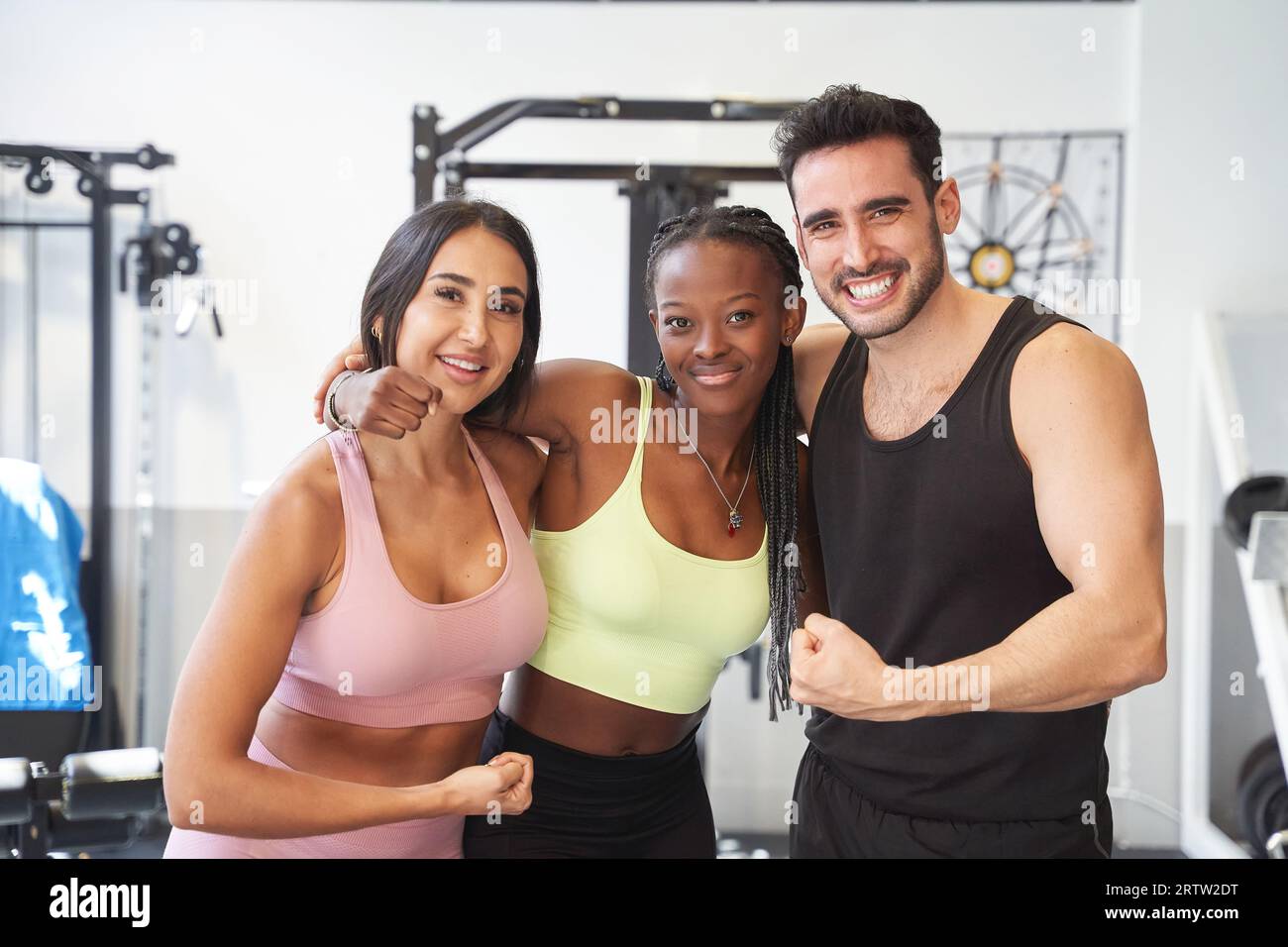 group of fitness friends flexing their arm very happy and smiling at ...