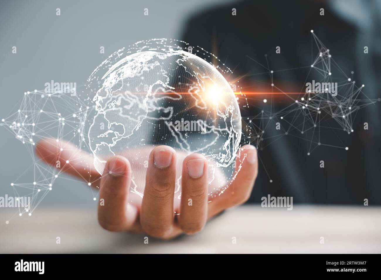 A businessman's hand holds a globe, illustrating seamless connectivity ...
