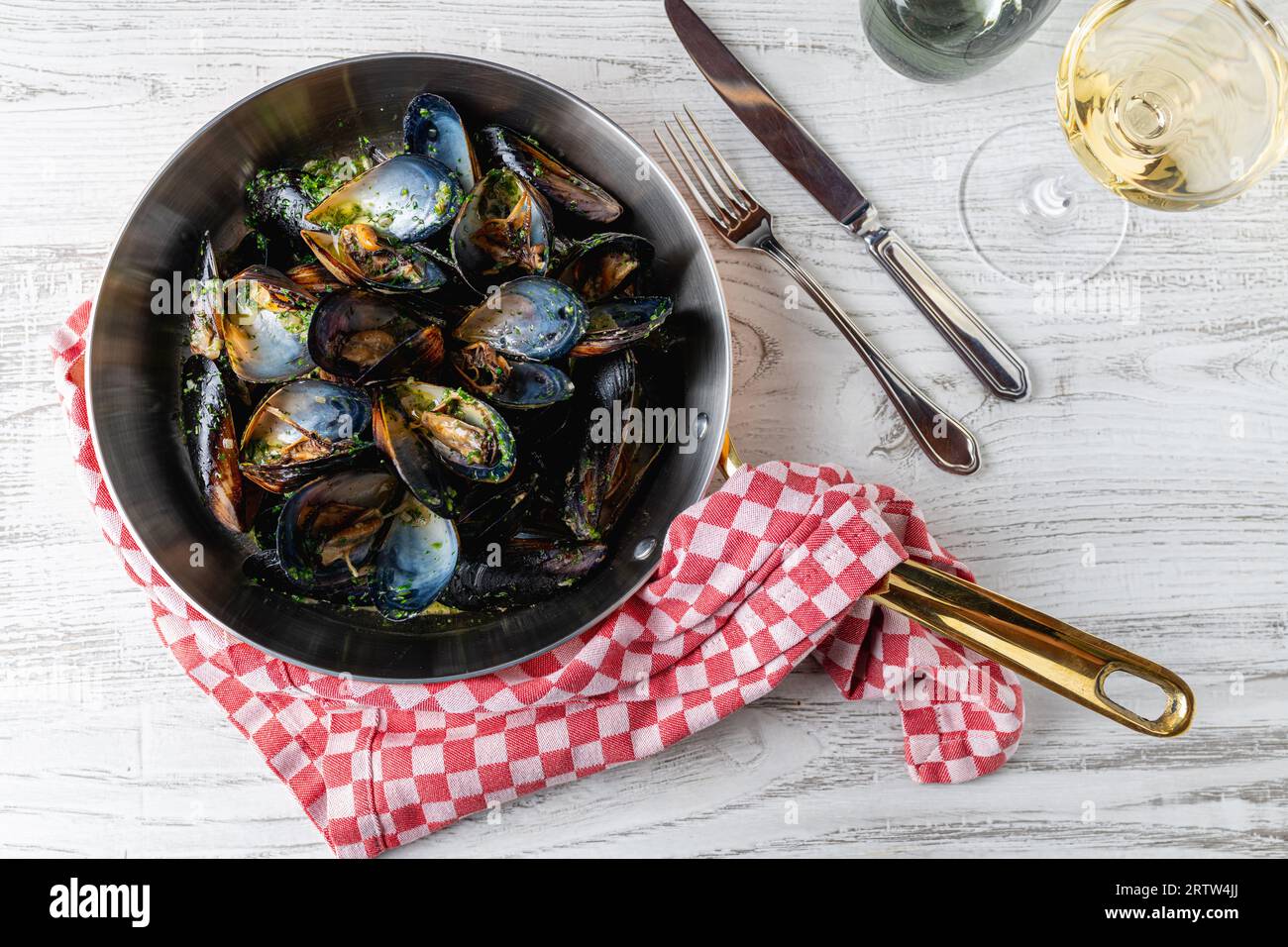 Baked blue mussels in spicy with lemon in a black cast-iron pot Stock ...