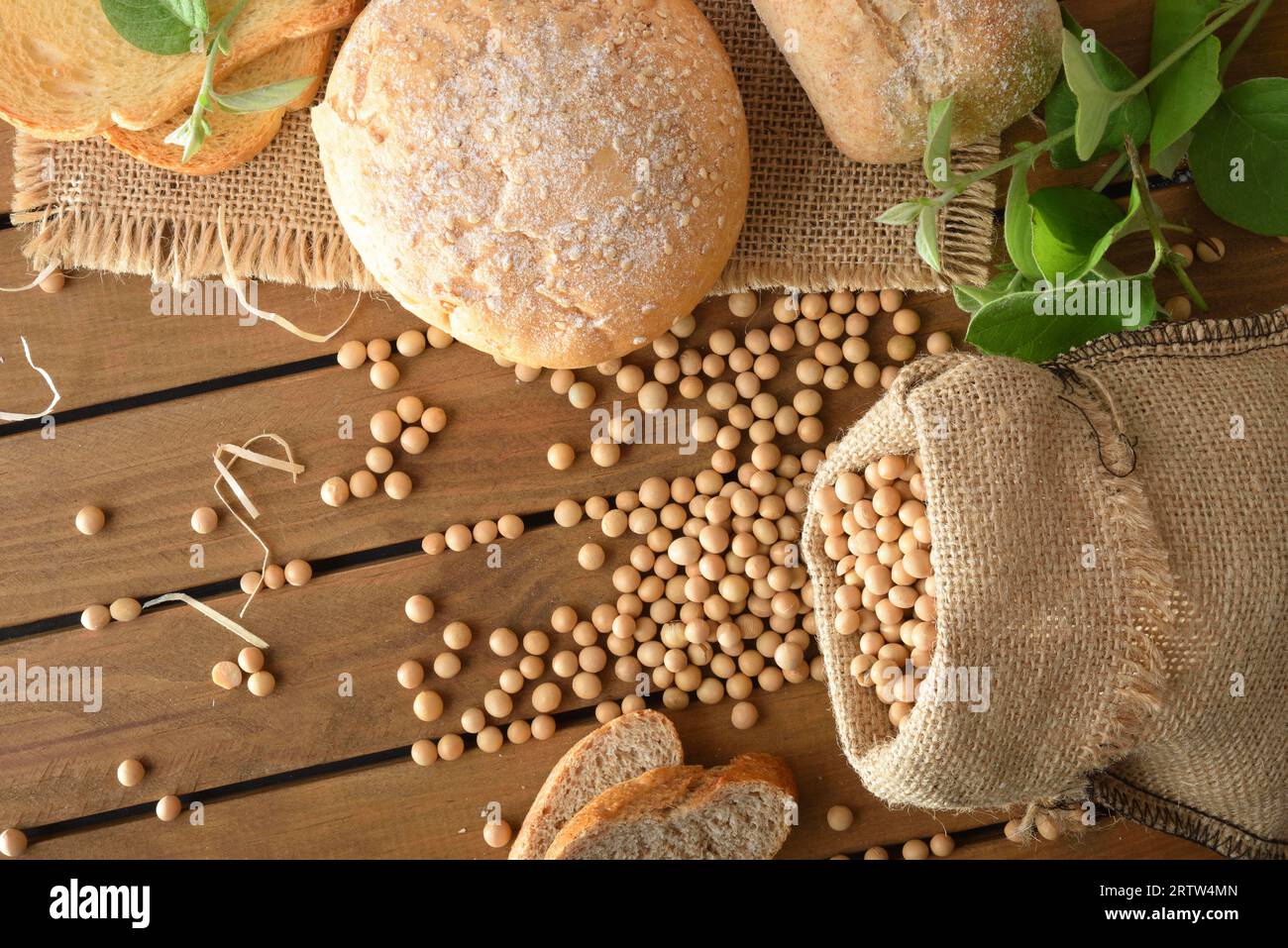 Sack full of soybeans on rustic wooden table with soybean bread and ...
