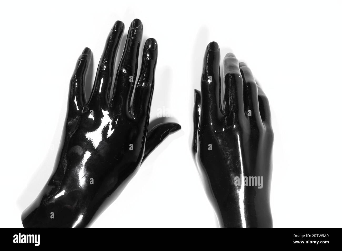 Two black mannekin hands displayed against a plain white background ...