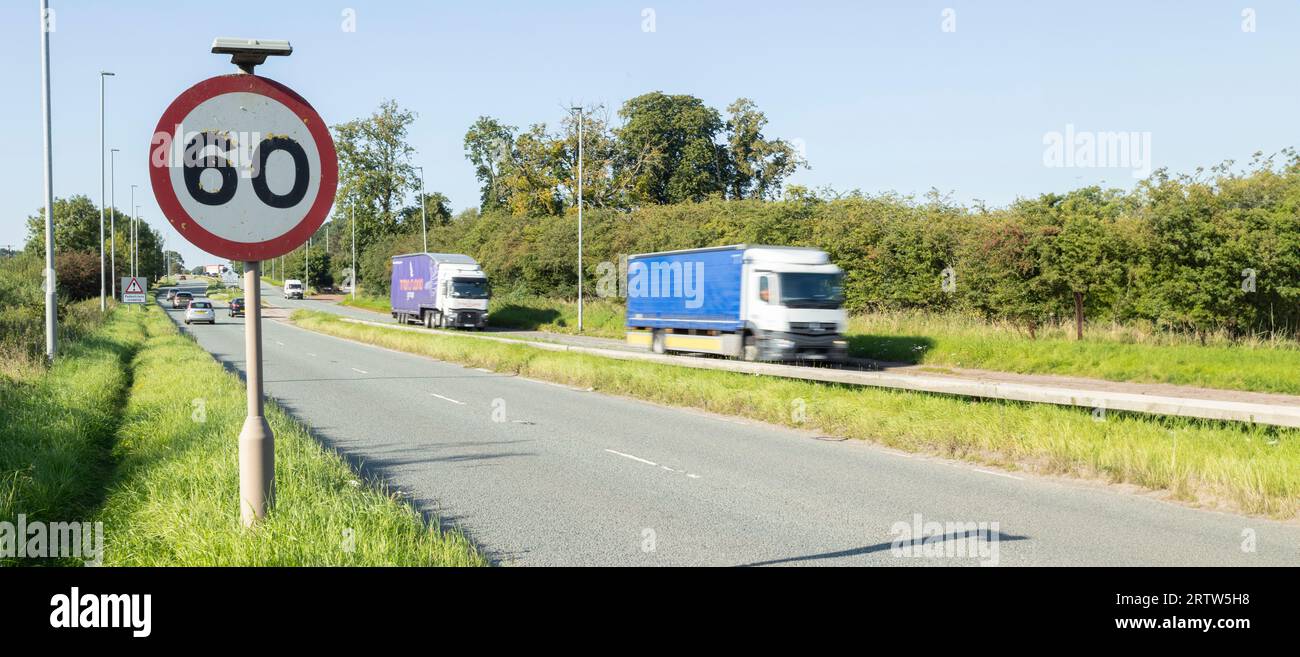 fast moving heavy goods vehicle passes a speed restriction sign Stock ...
