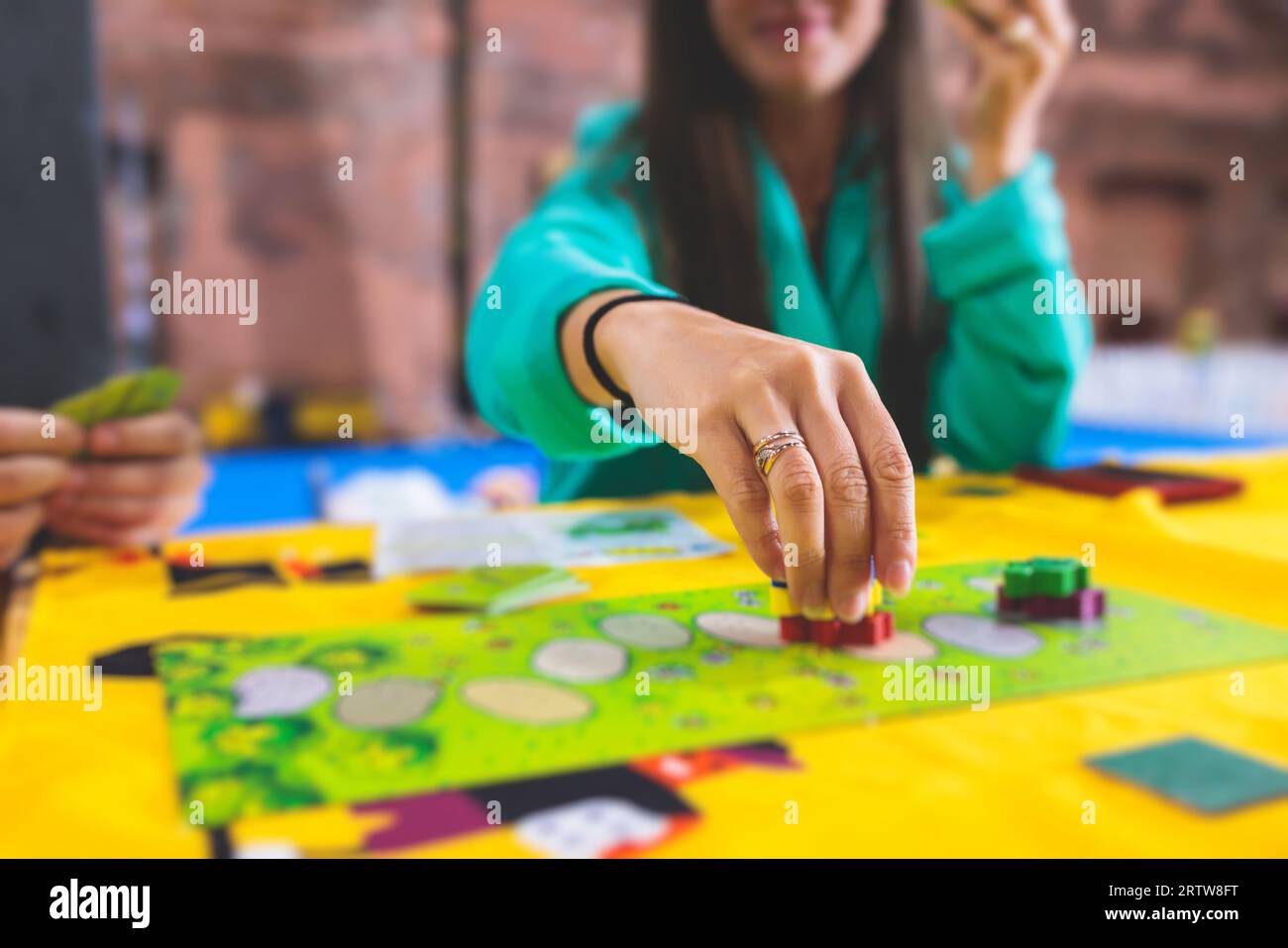 Process of playing board game and having fun with friends and family in ...