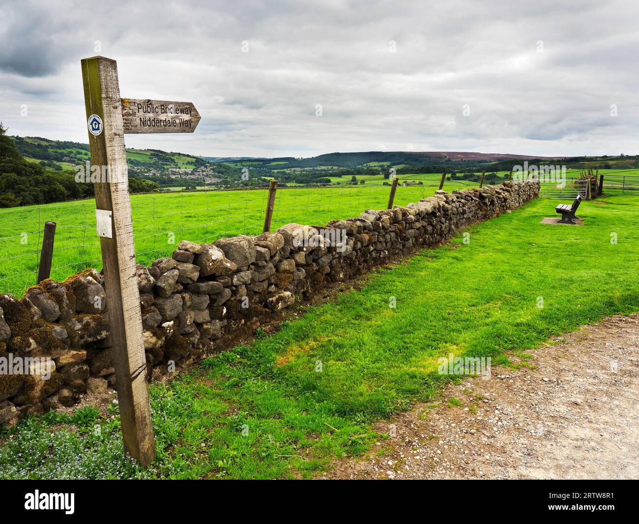 Nidderdale Way fingerpost and a bench with a view near Heathfield ...