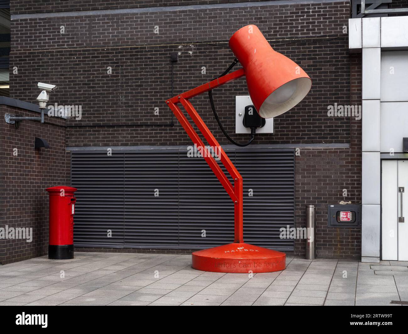 Artwork in the form of a giant red desk lamp at the entrance to the The ...