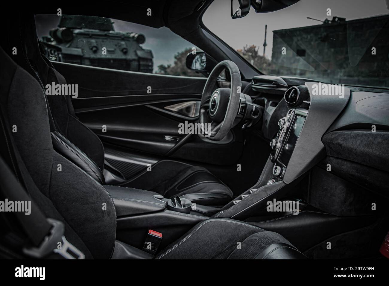 An interior view of a luxury black McLaren vehicle, with its sleek and ...