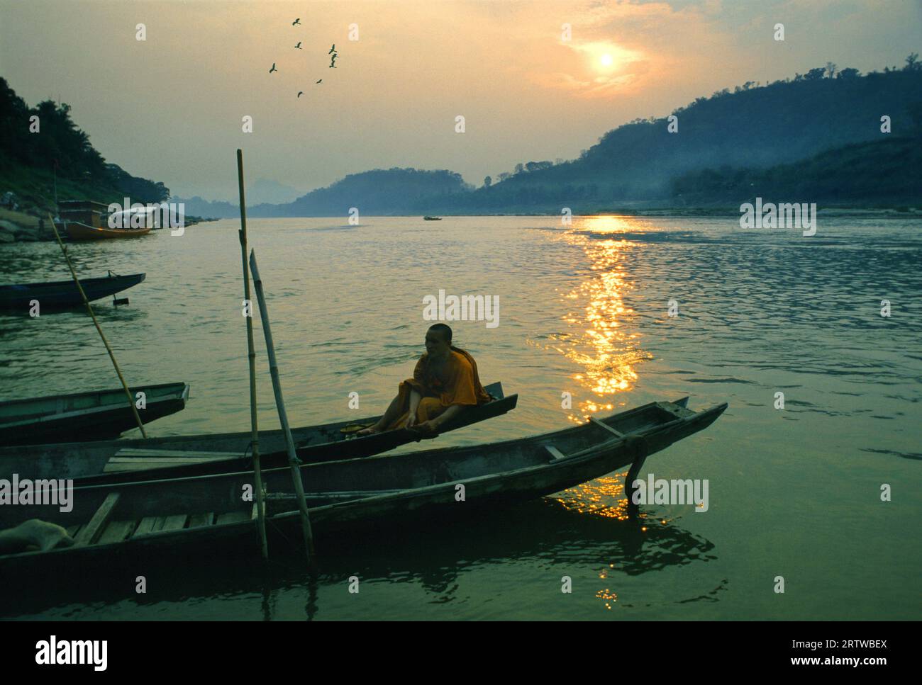 Mekong River, monk on boat Stock Photo - Alamy