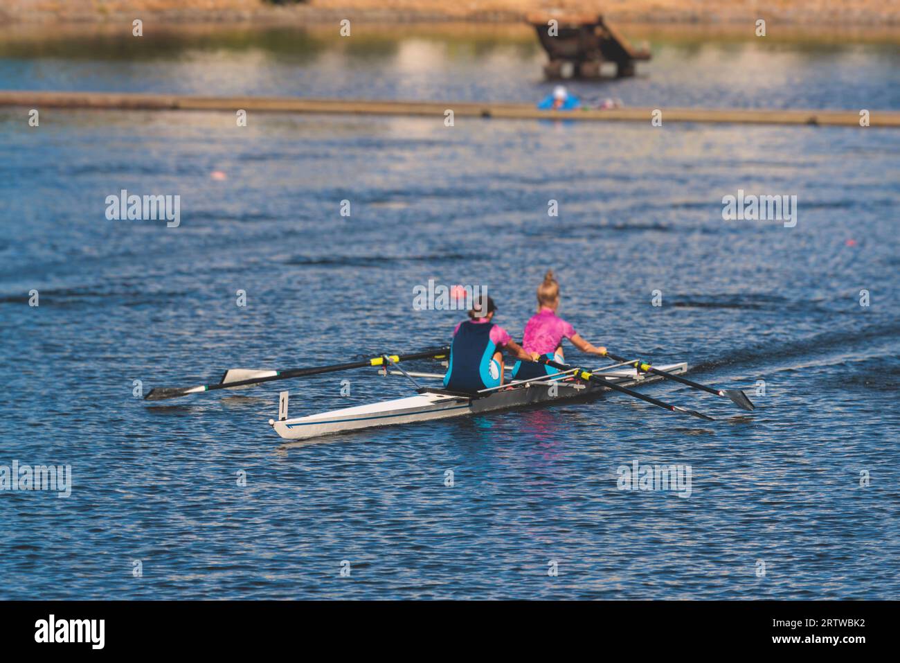 Group of rowing team female girl athletes sculling during competition ...
