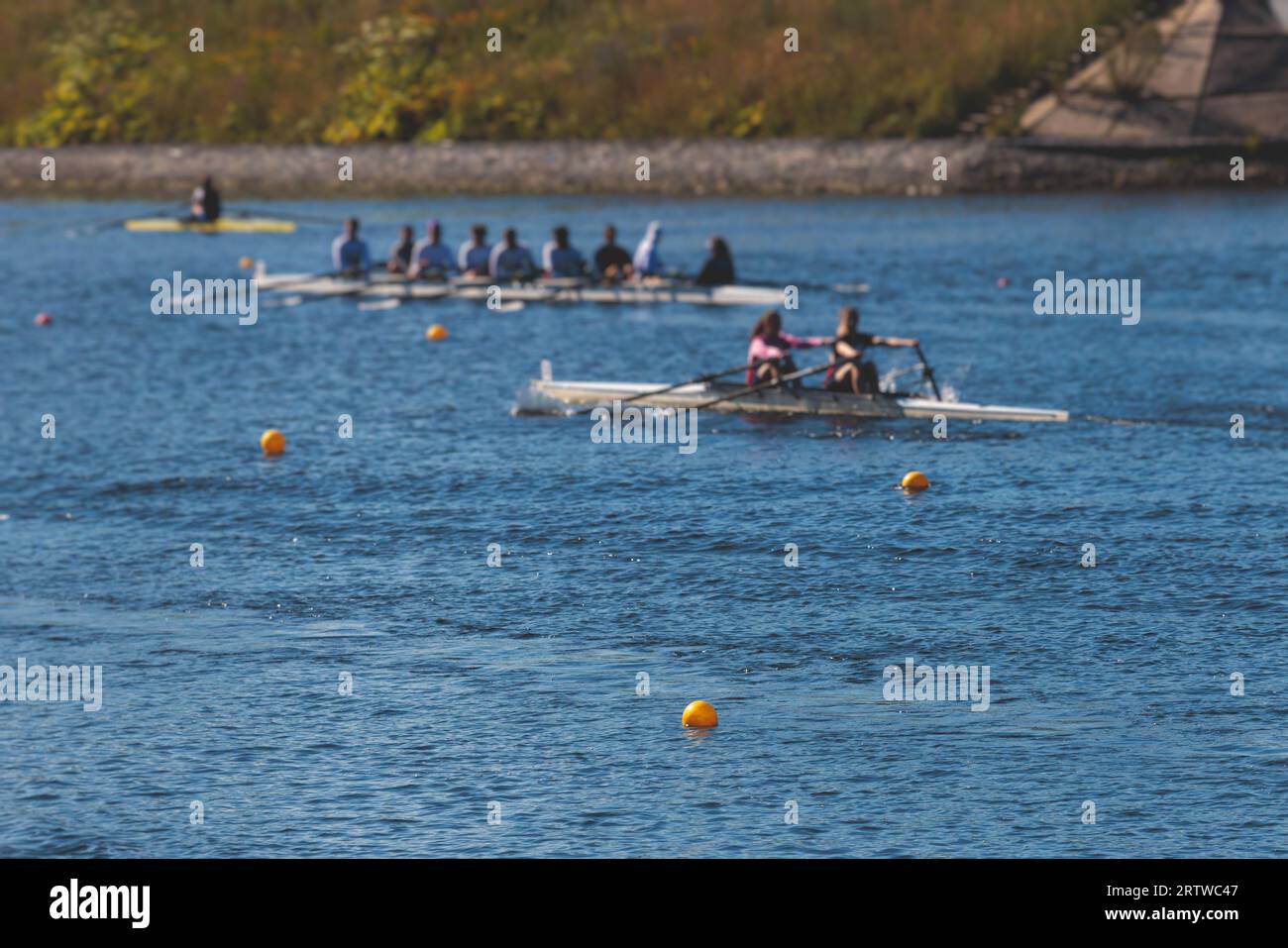 Group of rowing team athletes sculling during competition, kayak boats ...