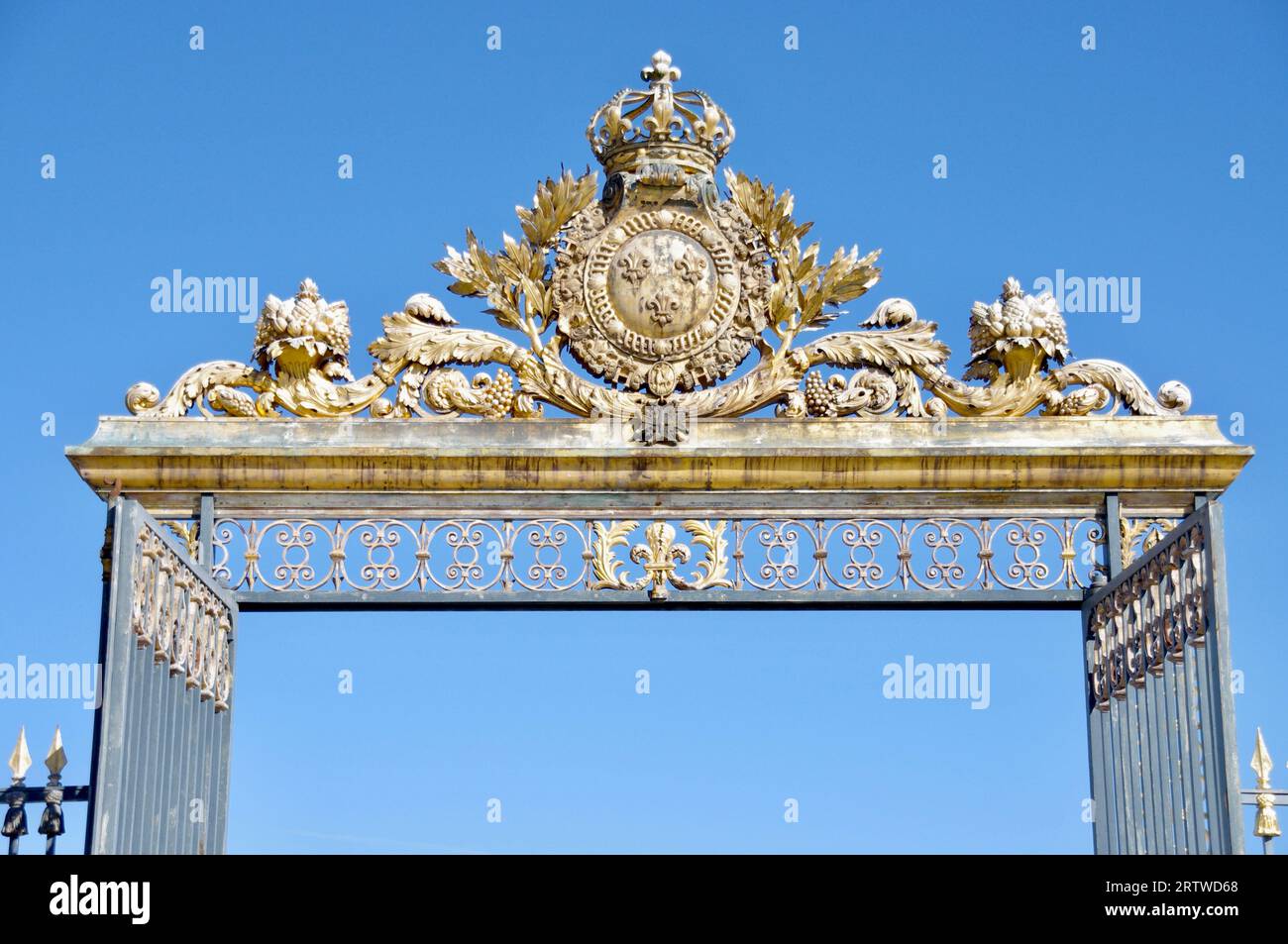 The beautiful Golden Gates outside The Palace of Versailles, under a ...