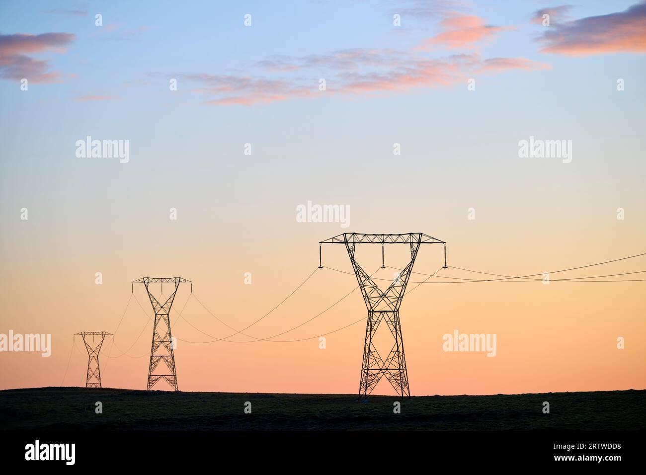 Overhead power lines in empty terrain Stock Photo - Alamy
