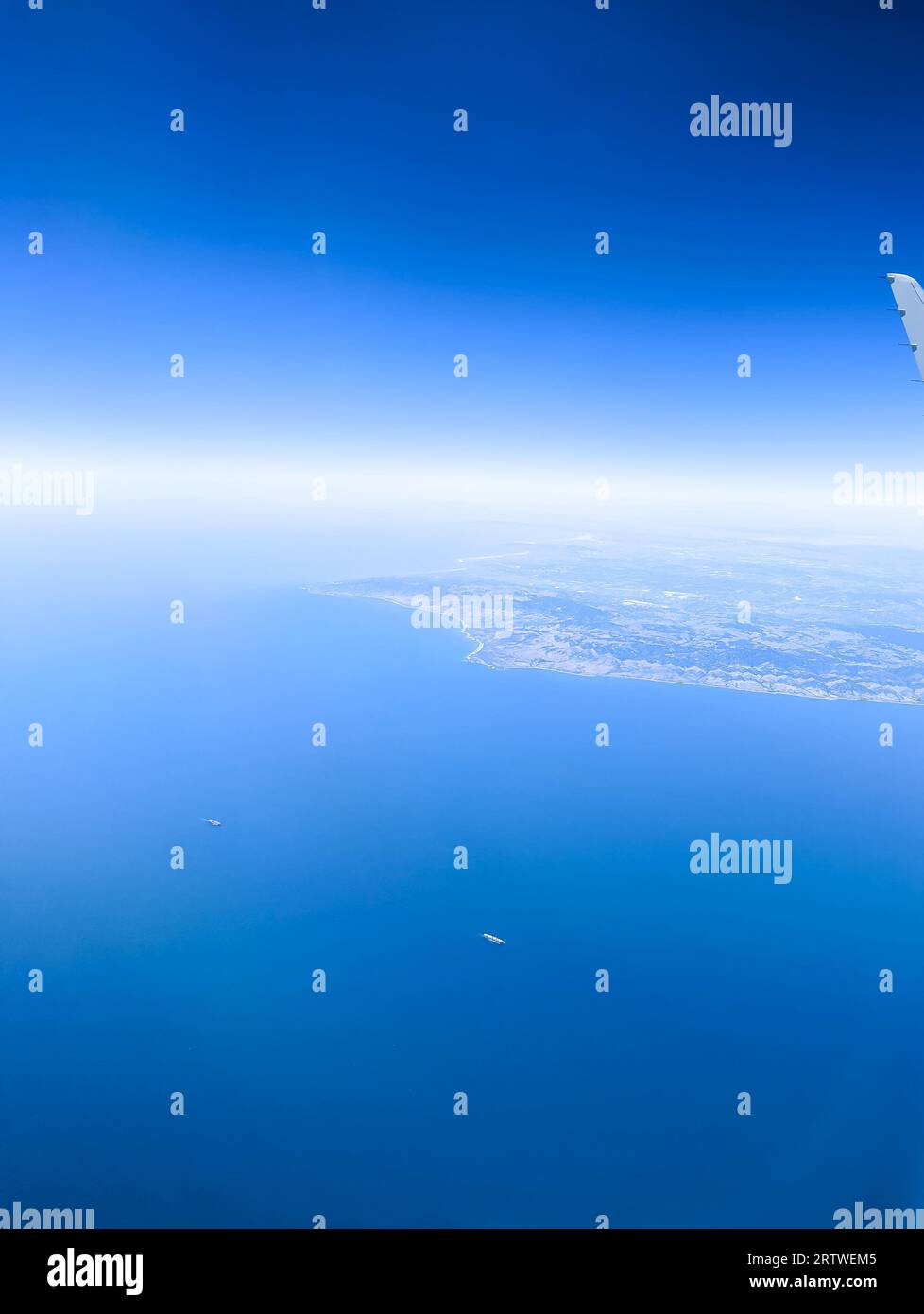 Aerial view of the coast of a tranquil ocean seen from an airplane ...
