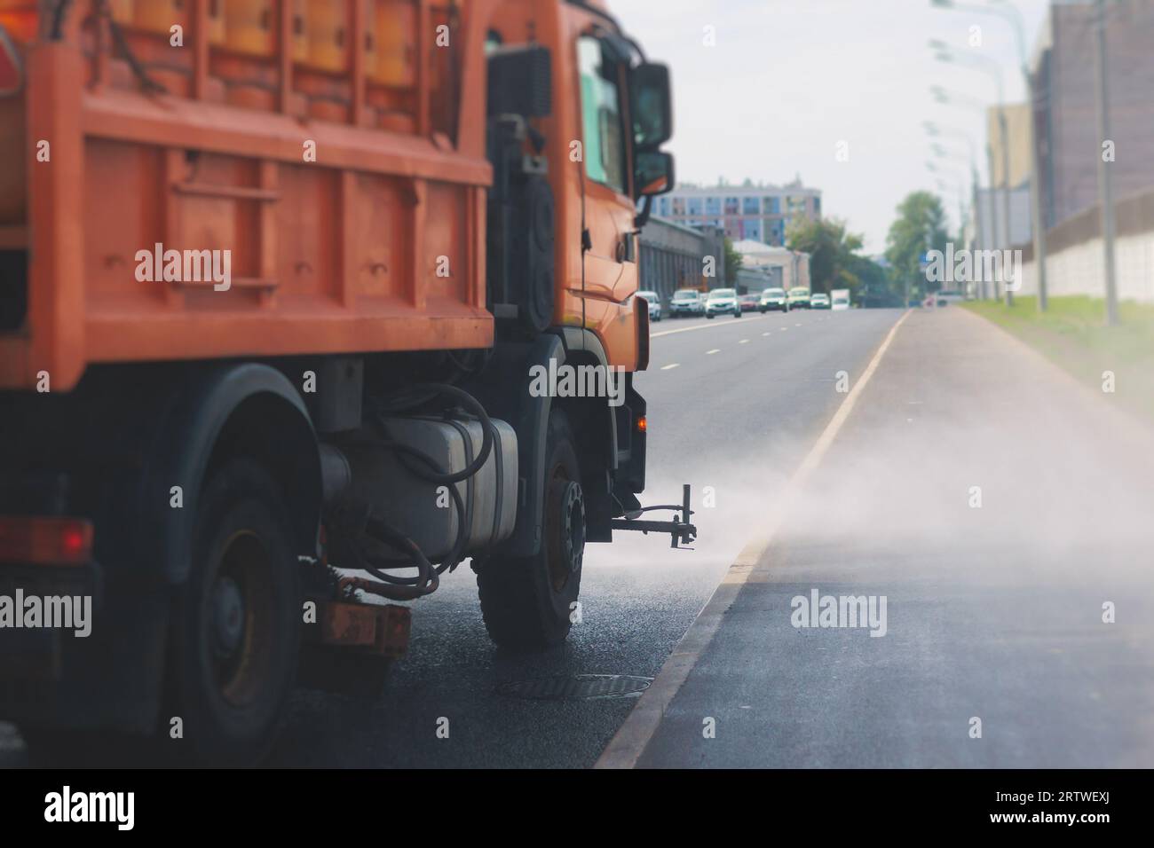 Municipal watering truck machines washes asphalt, process of street ...