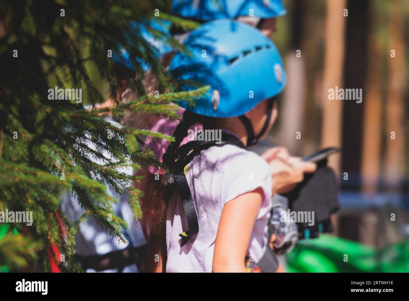 View of high ropes course, kids of climbing in amusement acitivity rope ...