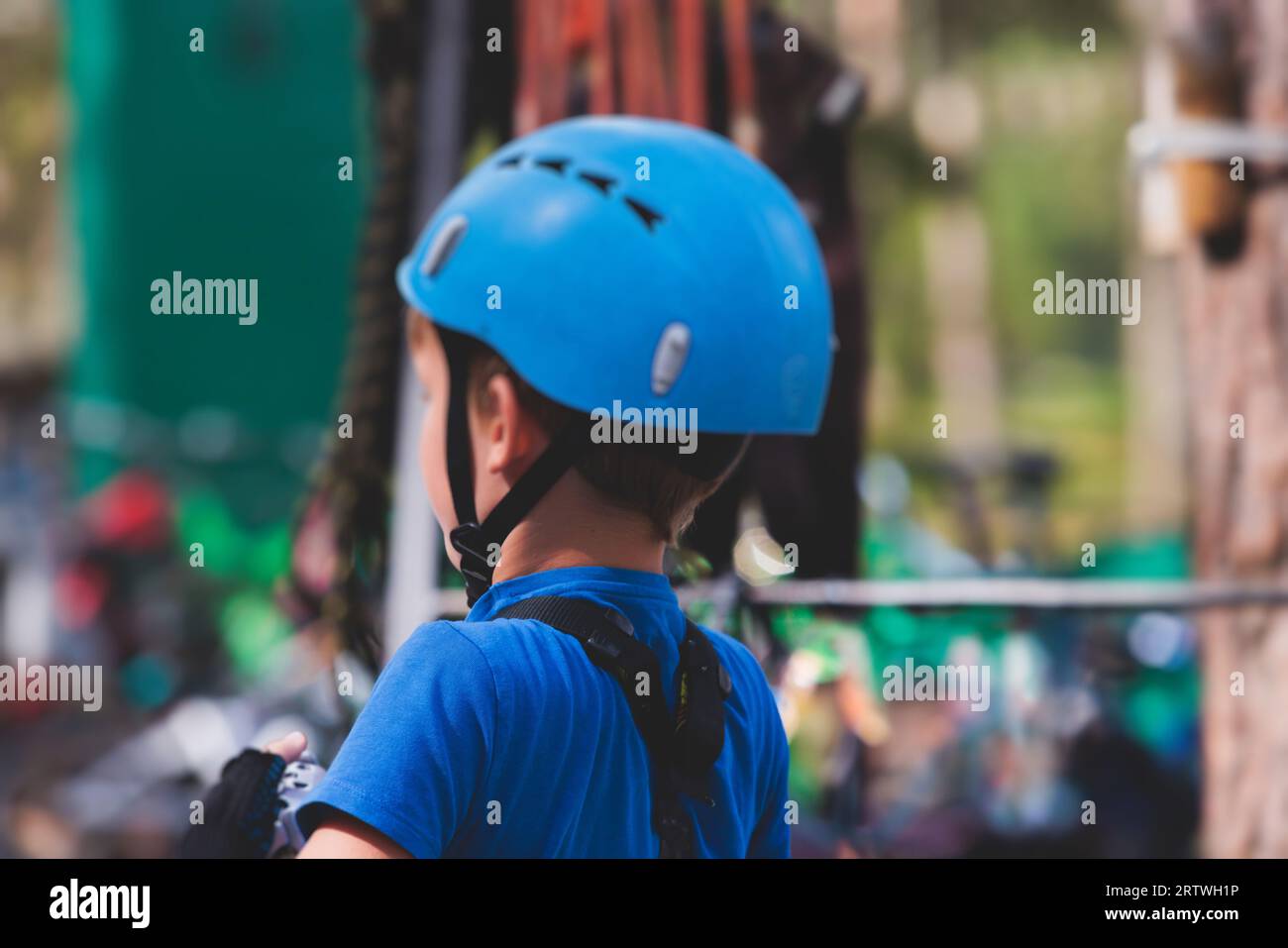 View of high ropes course, kids of climbing in amusement acitivity rope ...