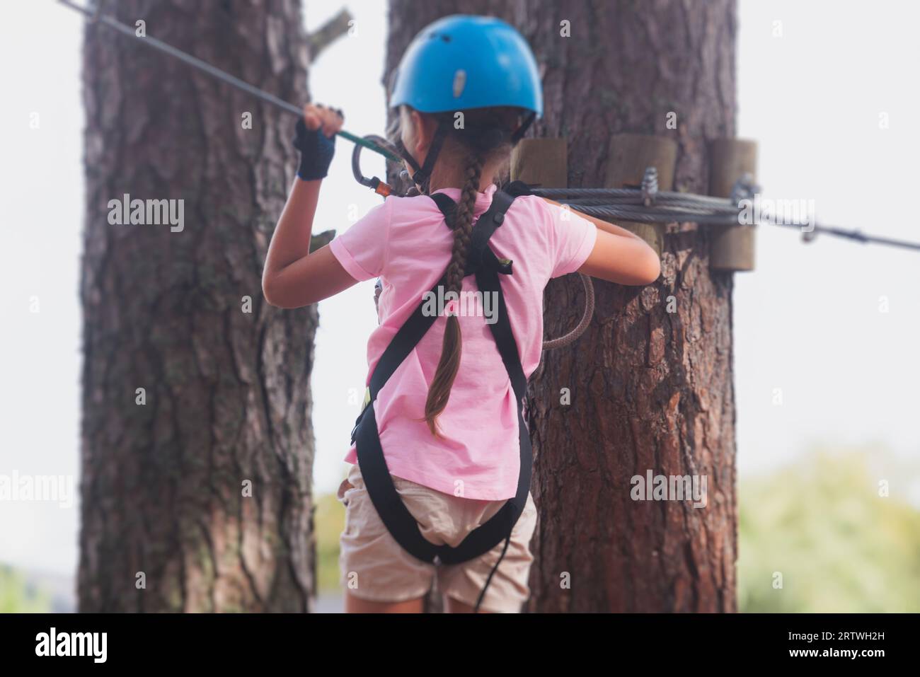 View of high ropes course, kids of climbing in amusement acitivity rope ...