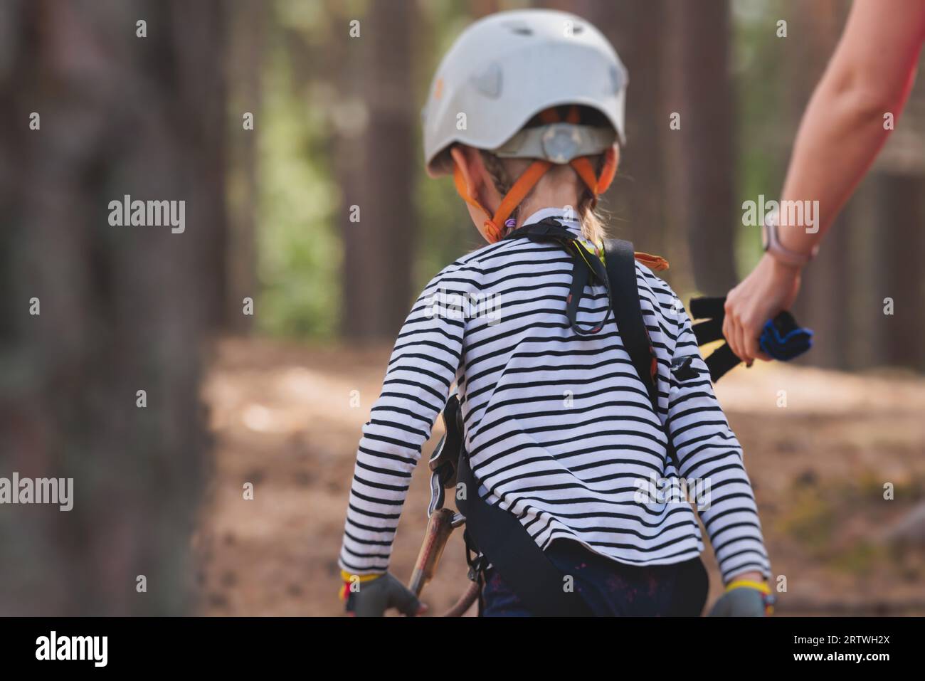 View of high ropes course, kids of climbing in amusement acitivity rope ...