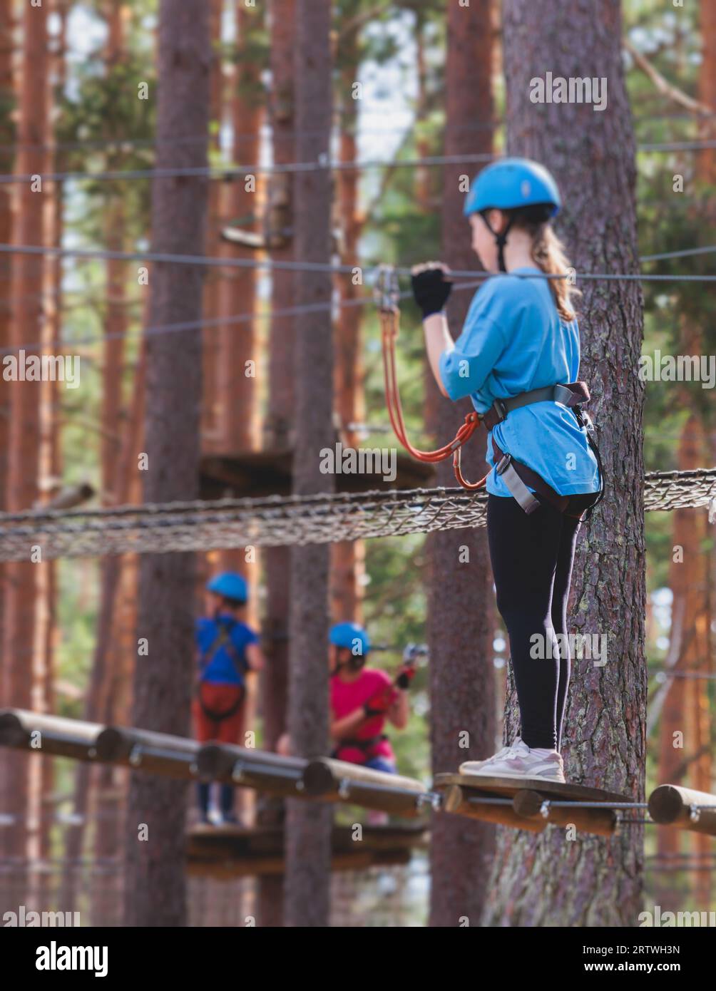 View of high ropes course, kids of climbing in amusement acitivity rope ...