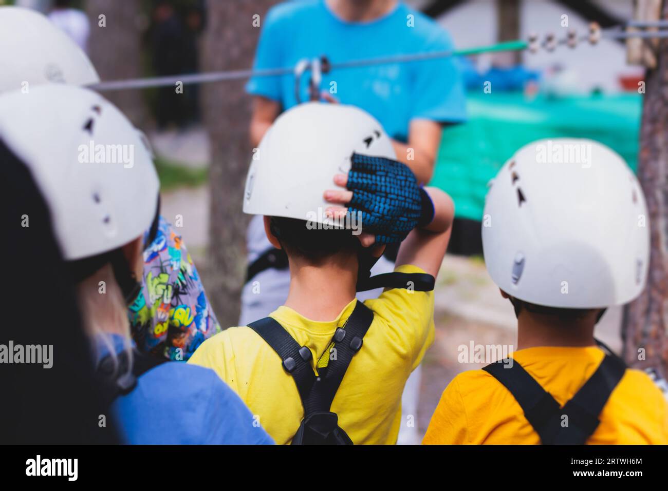 View of high ropes course, kids of climbing in amusement acitivity rope ...
