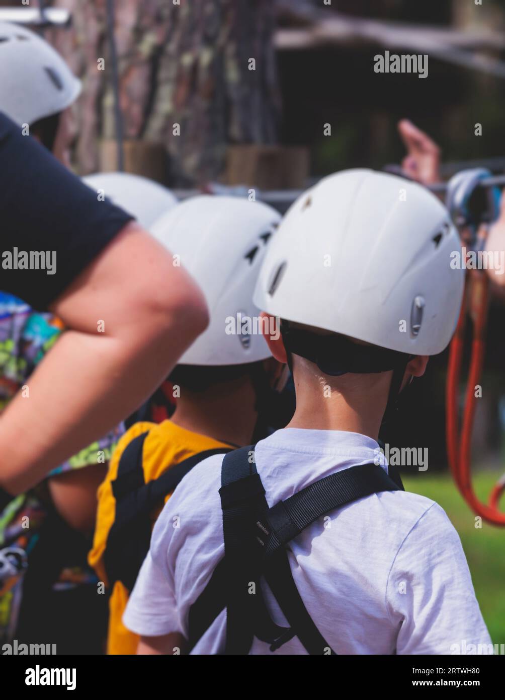 View of high ropes course, kids of climbing in amusement acitivity rope ...