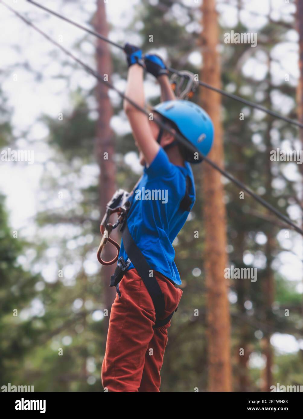 View of high ropes course, kids of climbing in amusement acitivity rope ...