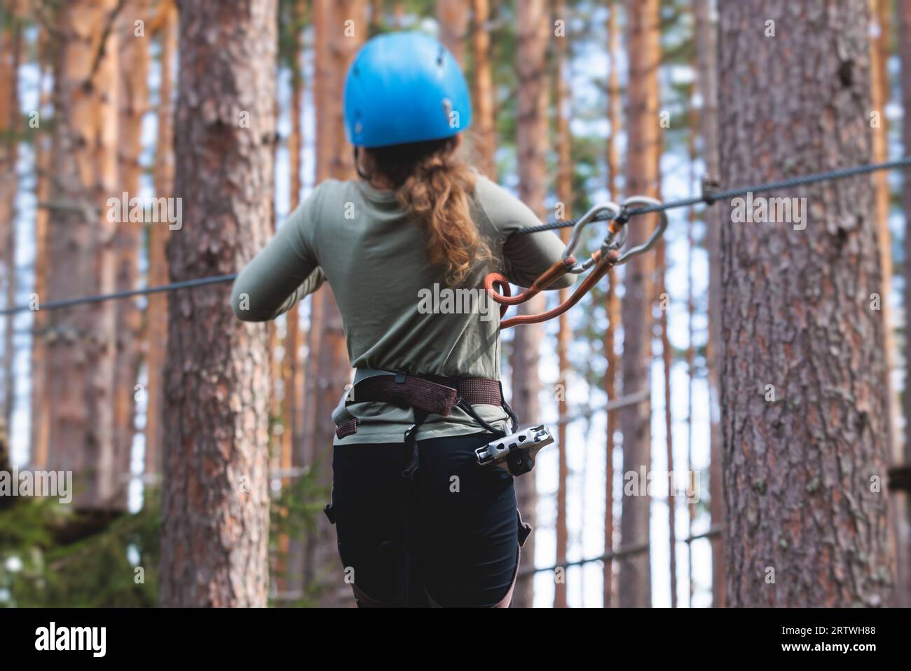 View of high ropes course, kids of climbing in amusement acitivity rope ...