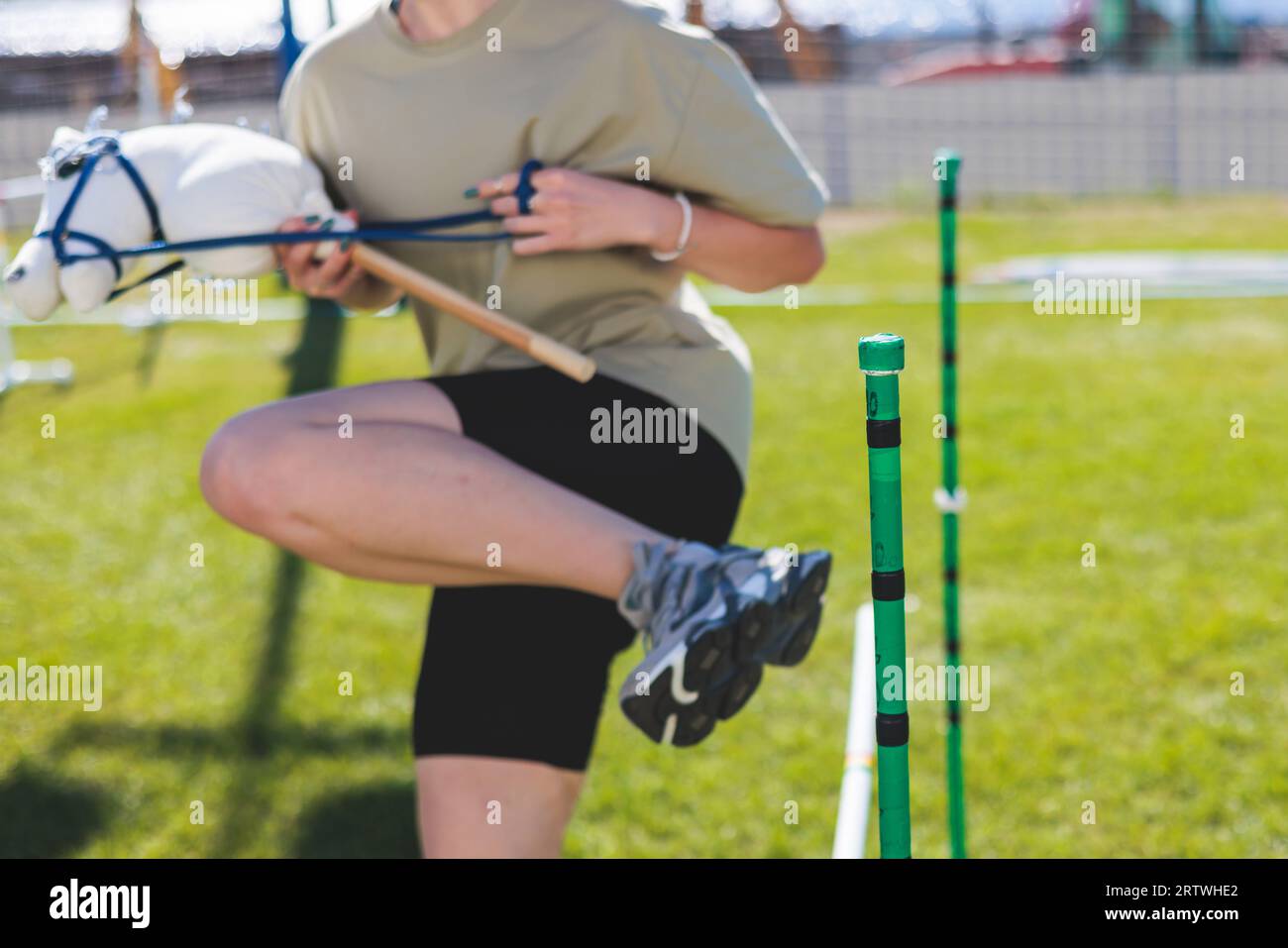 Hobby horsing competition on a green grass, hobby horse riders jumping ...