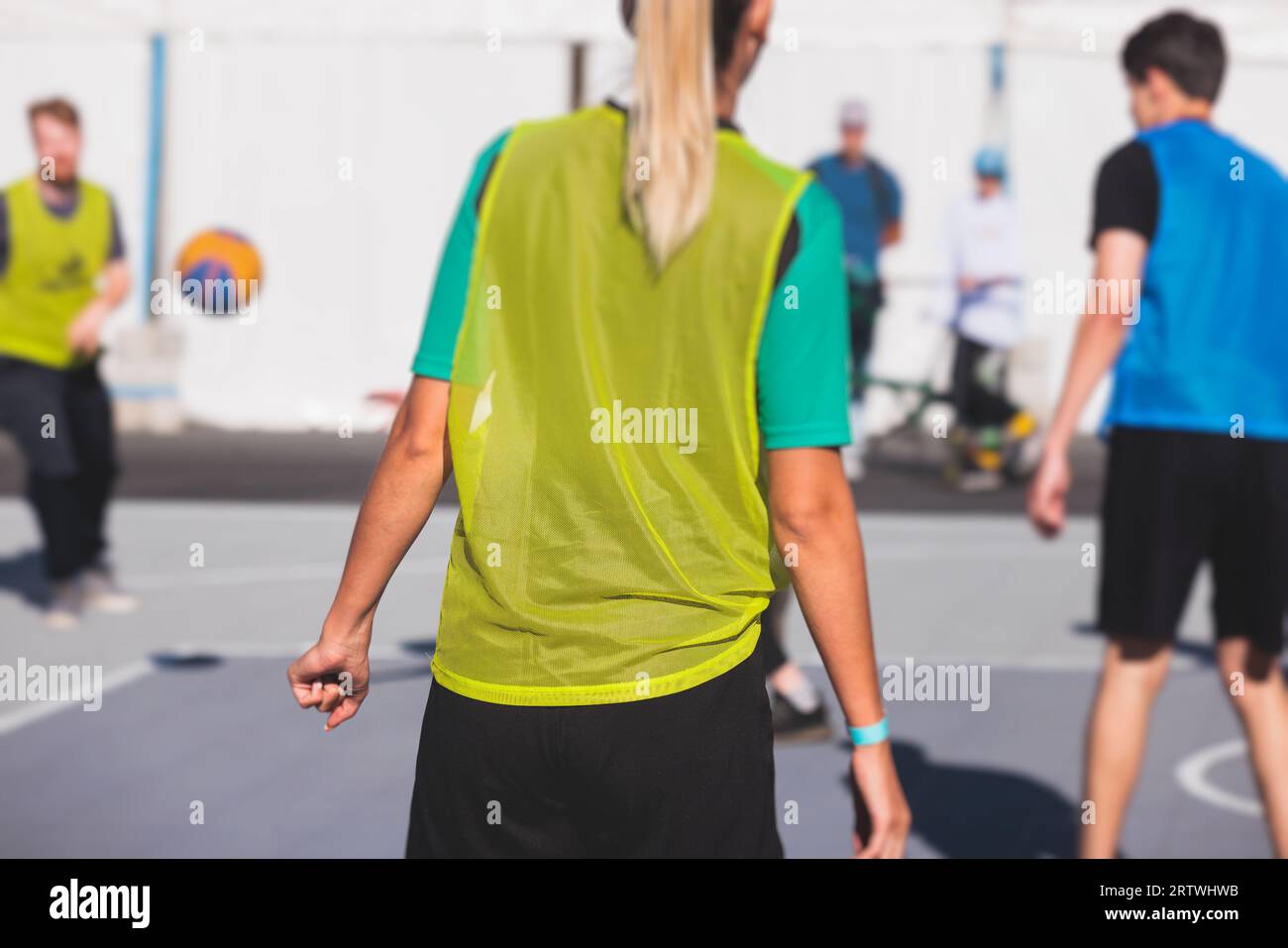 Female athletes play basketball, teenage team play street basketball ...