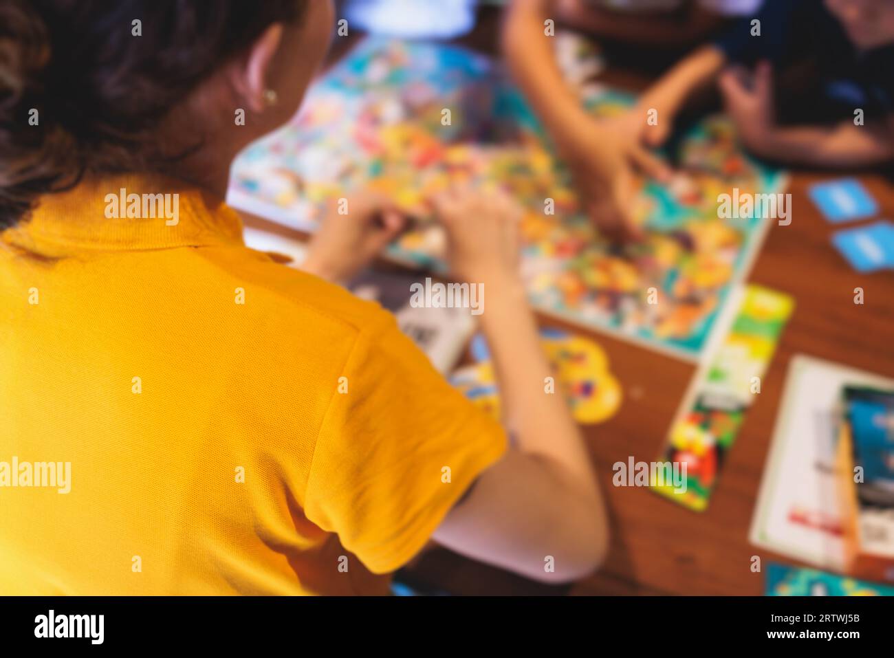 Process of playing board game and having fun with friends and family in ...