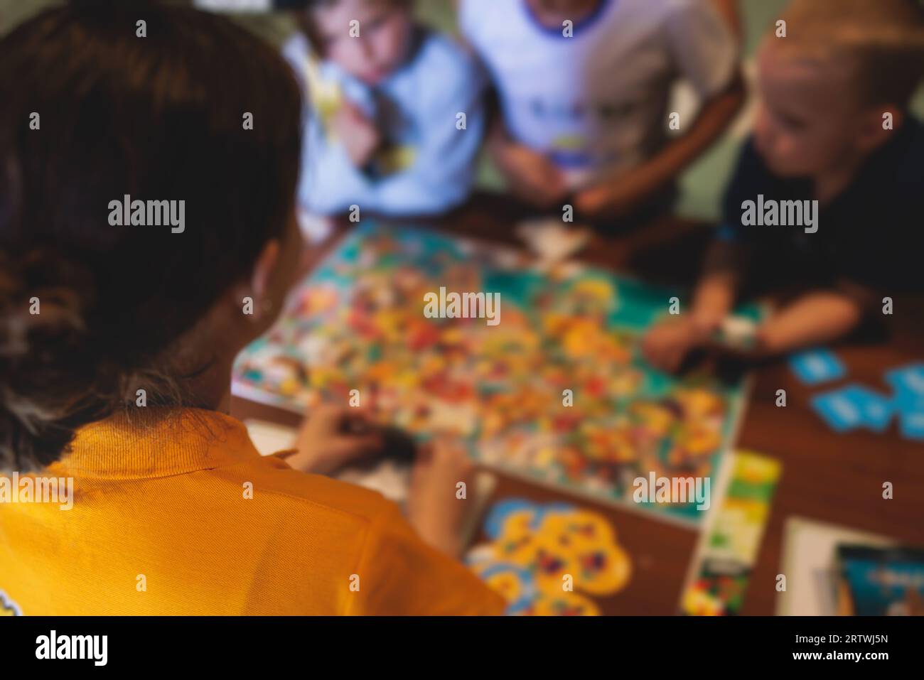 Process of playing board game and having fun with friends and family in ...