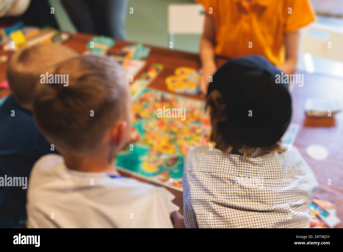 Process of playing board game and having fun with friends and family in ...