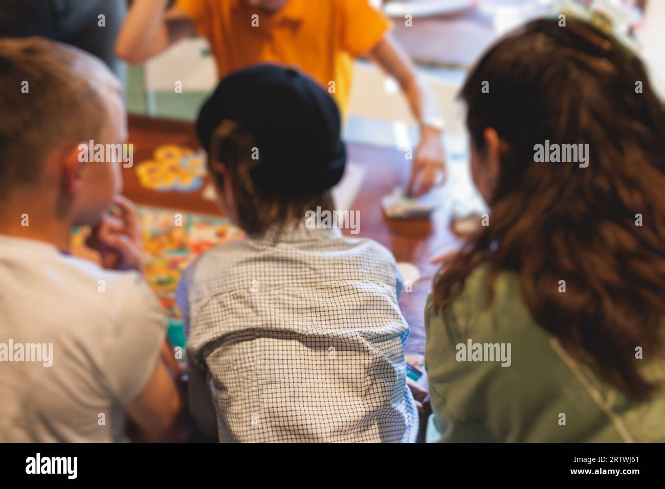 Process of playing board game and having fun with friends and family in ...