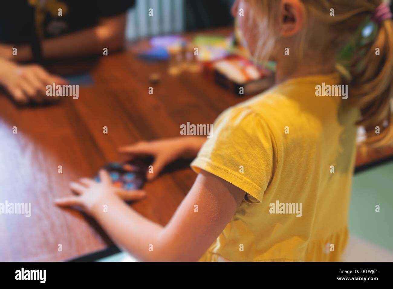 Process of playing board game and having fun with friends and family in ...