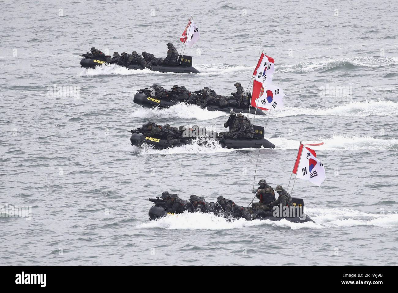 South Korean military vessels take part in a ceremony replicating the ...