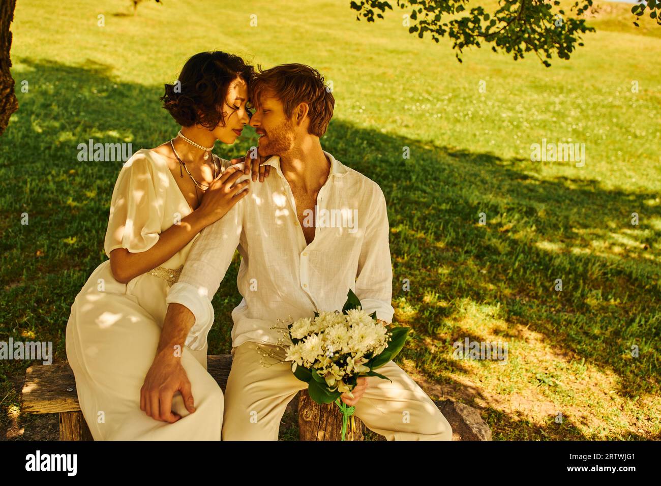Rural Wedding Interracial Just Married Couple Sitting Under Tree With Bridal Bouquet Newlyweds