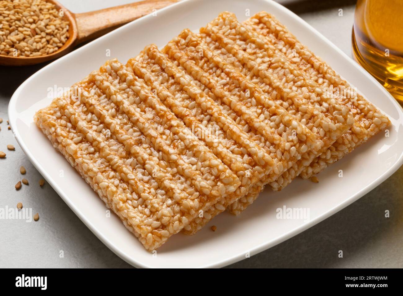 Plate with white homemade sesame snaps close up Stock Photo - Alamy