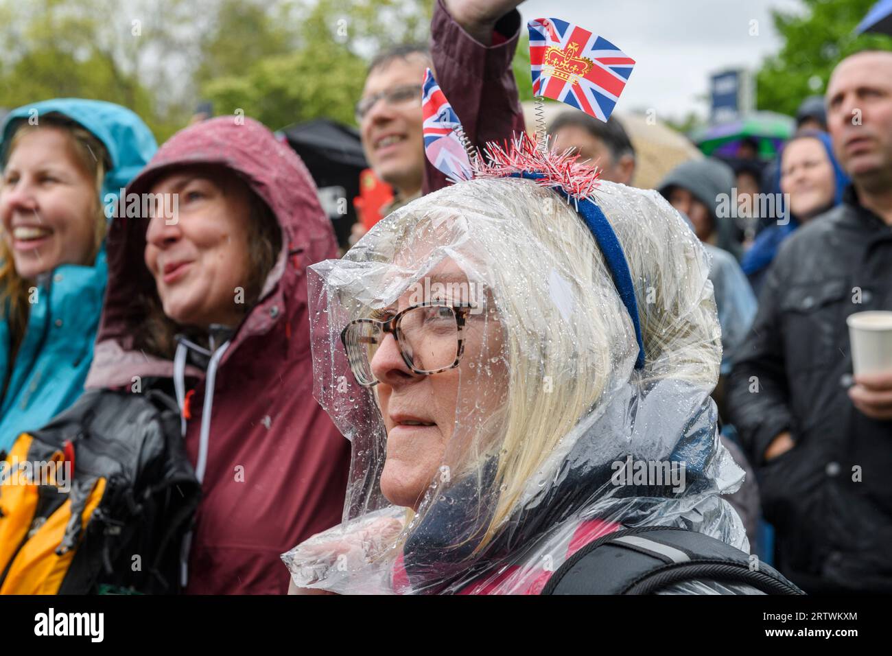 A large crowd braving the rain to watch the coronation of King Charles ...