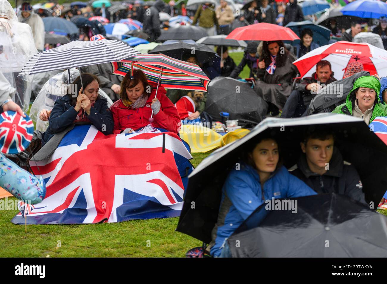 A large crowd braving the rain to watch the coronation of King Charles ...