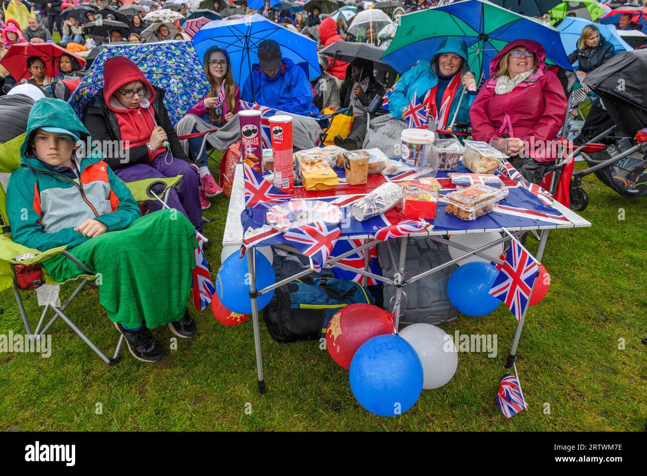 A group sat with their picnic in the rain, as they watch ed the ...