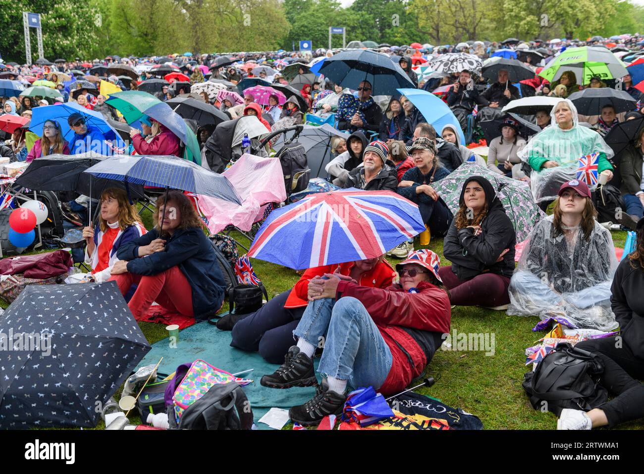 A large crowd braving the rain to watch the coronation of King Charles ...
