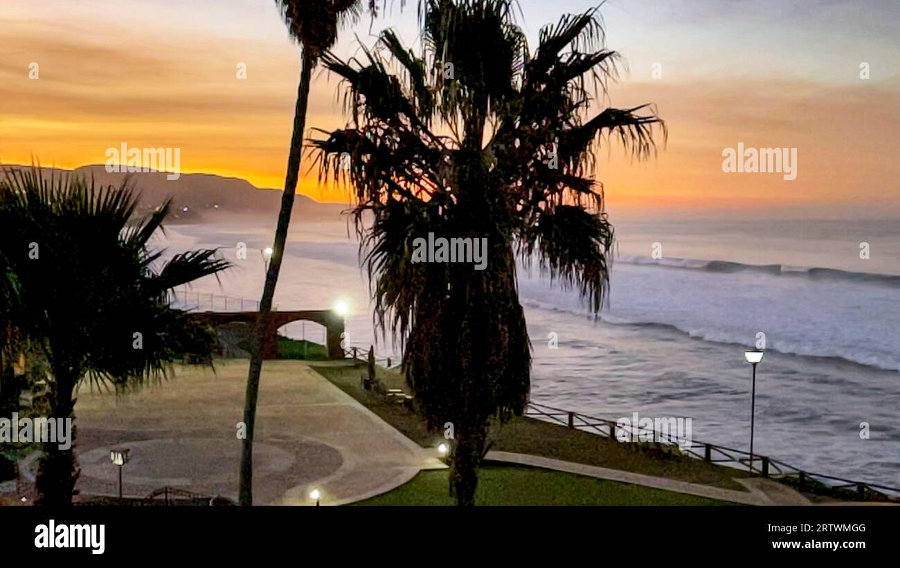 Sunrise on the Pacific Ocean in the fishing village of Puerto Nuevo, a ...