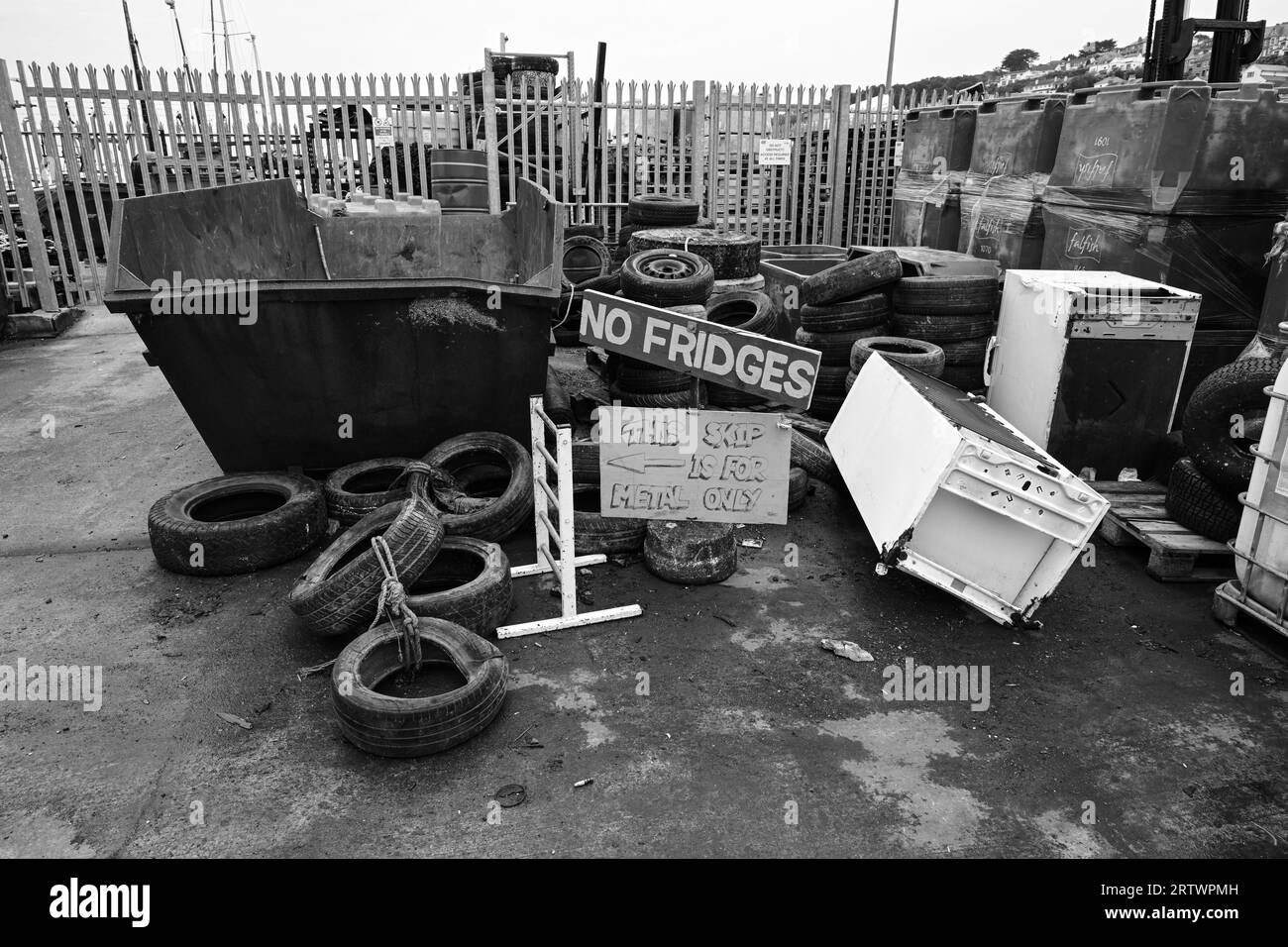 Skip with tyres and sign saying no fridges scrap Stock Photo - Alamy